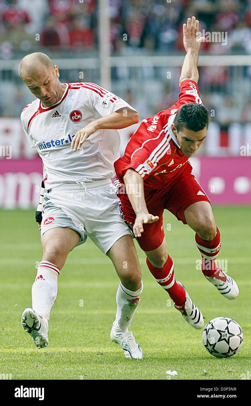 Lucio (R) of FC Bayern Munich vies for the ball with Ivica Banovic of ...