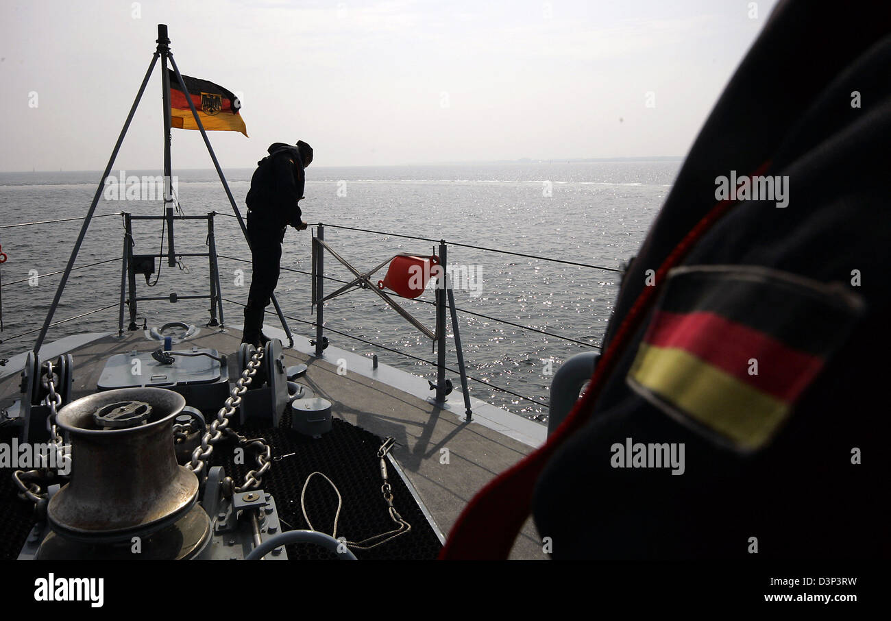 A soldier holds stands at the stern of the minehunter 'Kulmbach' after ...