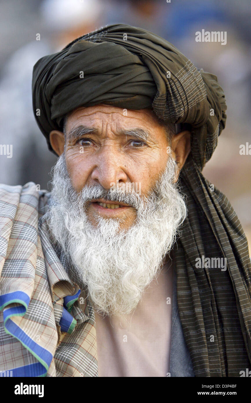 An elderly man with beard and turban photographed at the side of the ...