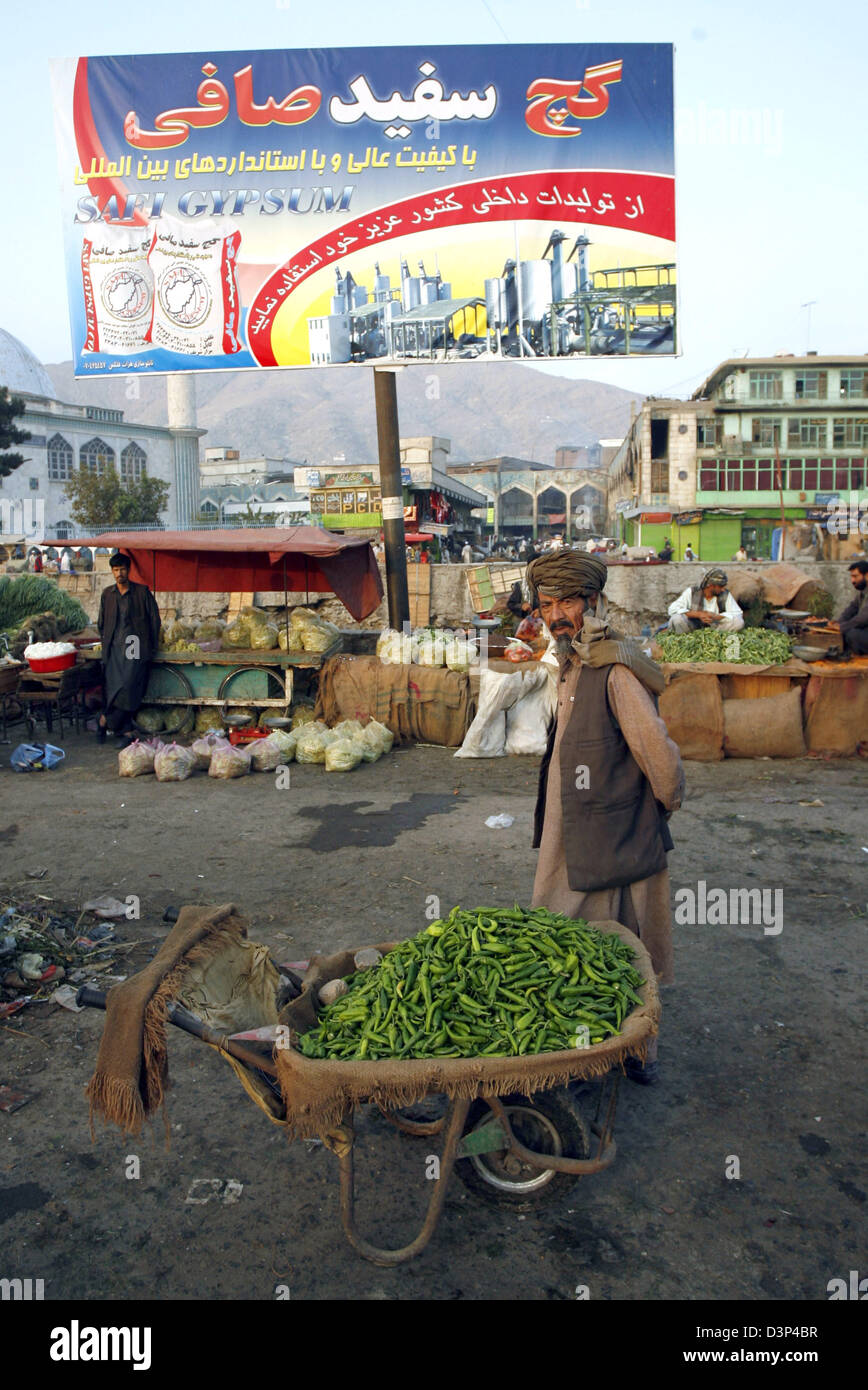 The picture shows merchants at a market with a giant advertisement ...