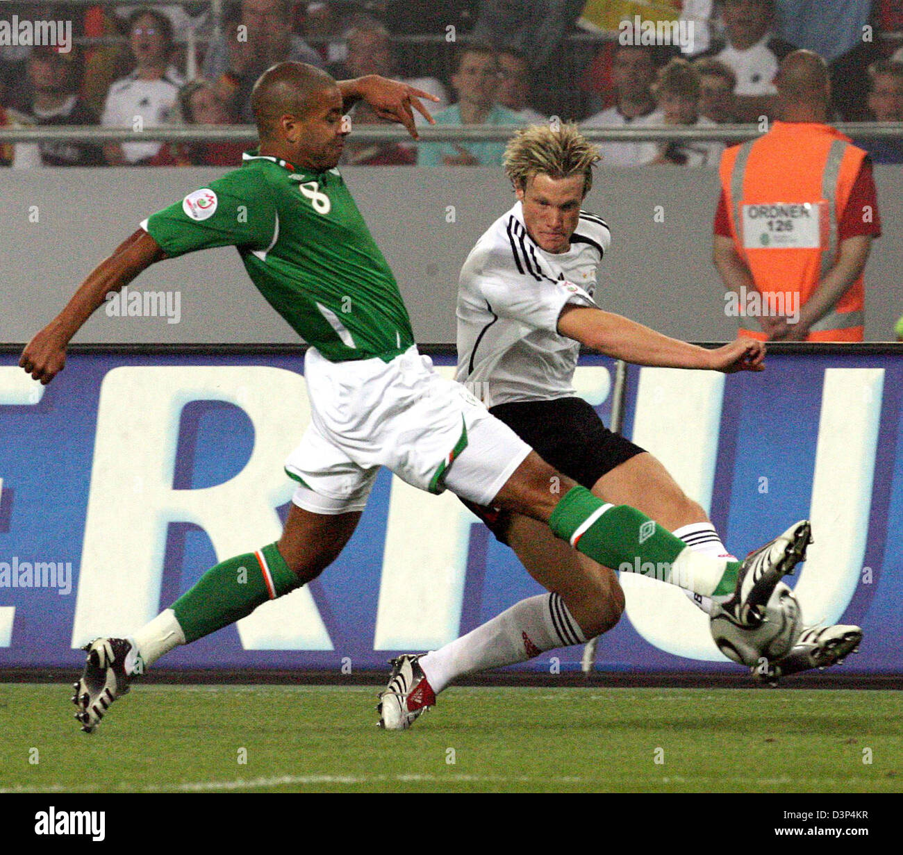 German international Marcel Jansen (R) tries to cross past Irish Steven ...