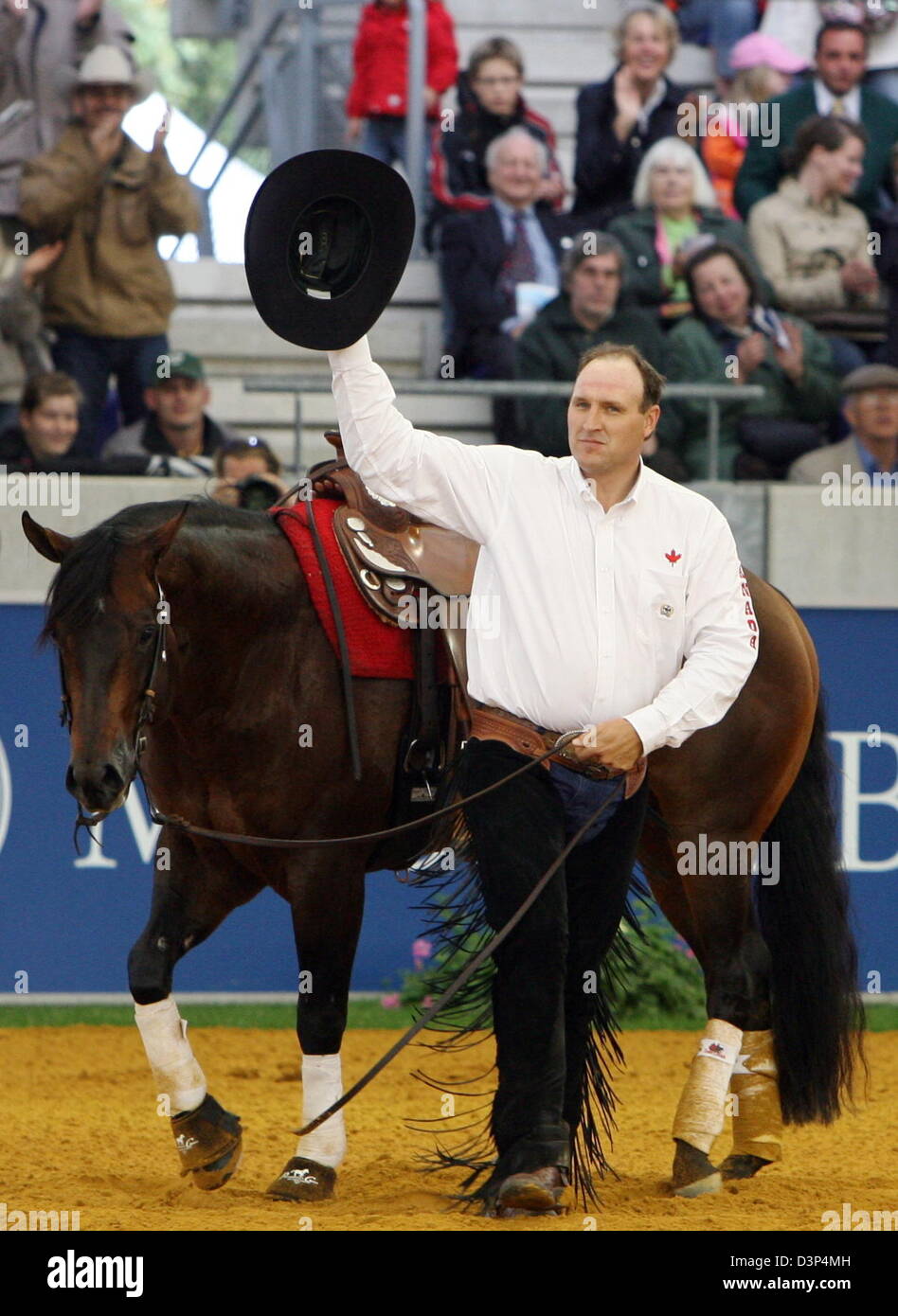 Canadian reining rider Duane Latimer waves to the crowd leading his ...