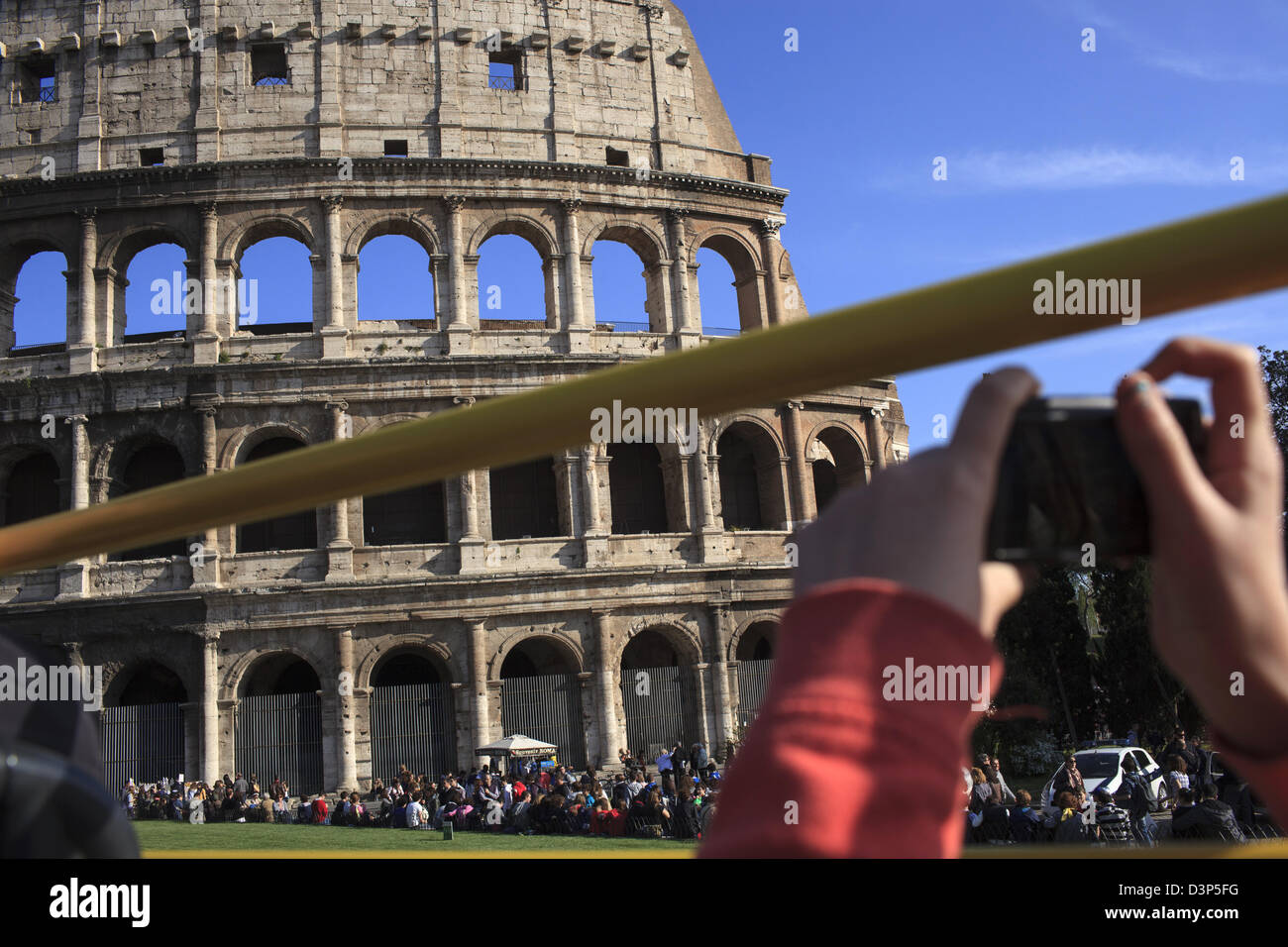Tourists on an open top bus tour of Rome taking photographs of the ...