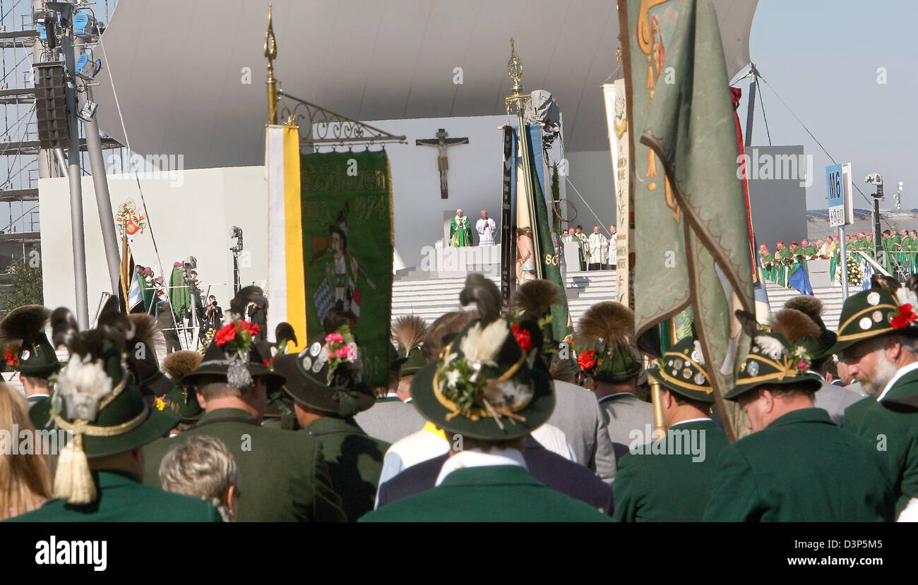Believers in traditional Bavarian clothes attend an open air ...