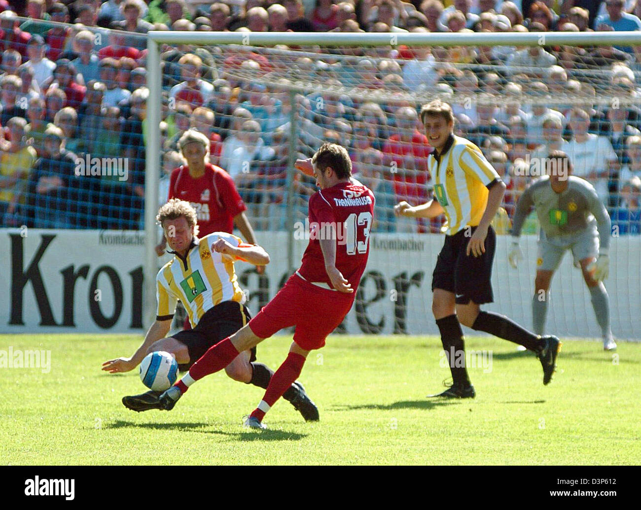 Thannhaus's Marc Haemmerle (C) and Dortmund's Christian Woerns (L) and ...