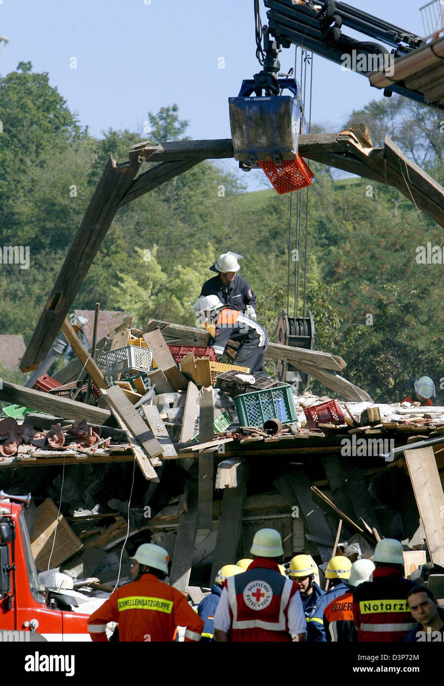 Firemen clear the debris of a destroyed backery which was destoyed by a ...