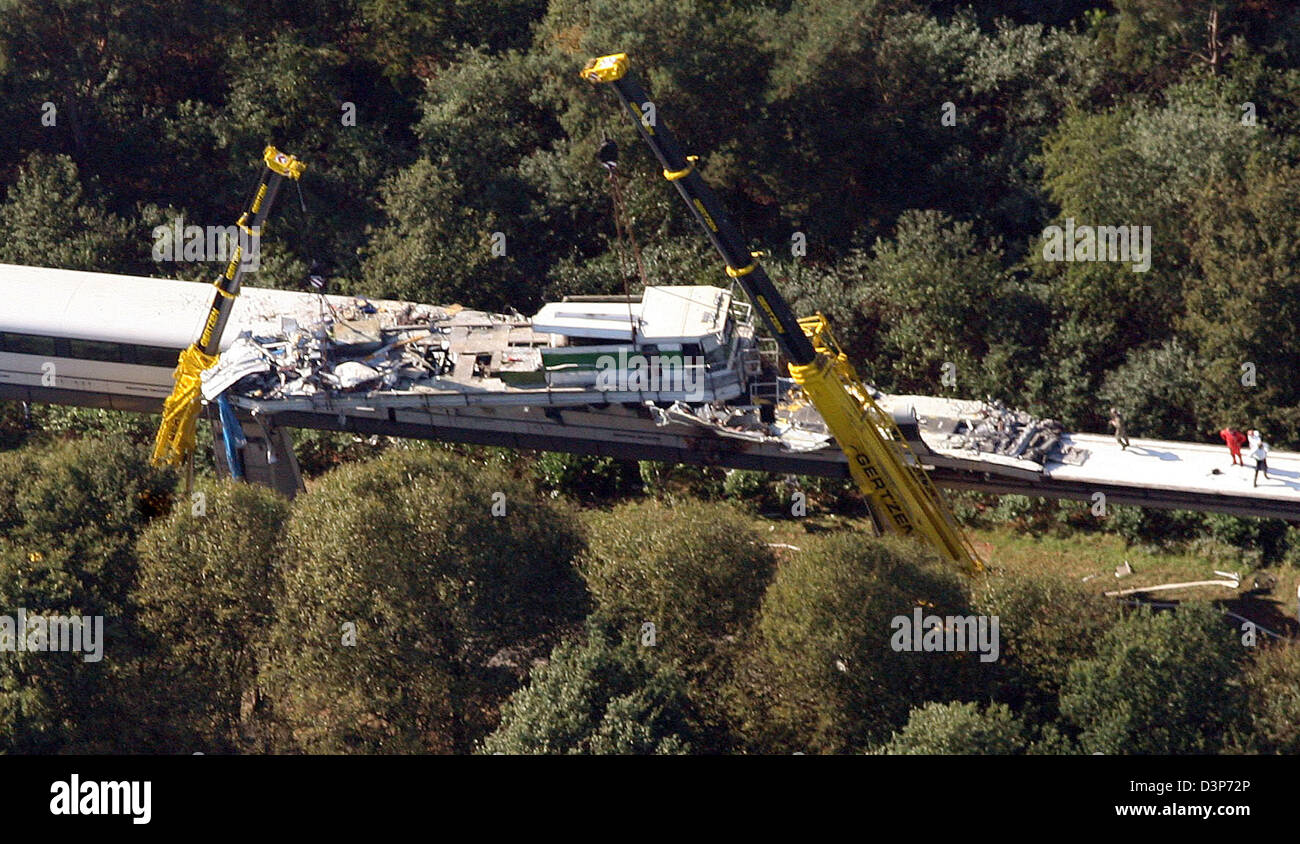 Two cranes remove the debris of a maintenance vehicle at the ...