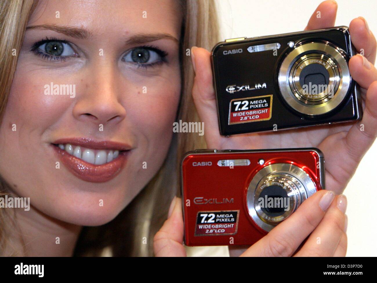A model presents two 'Casio Exilim' digital cameras at the trade fair ...