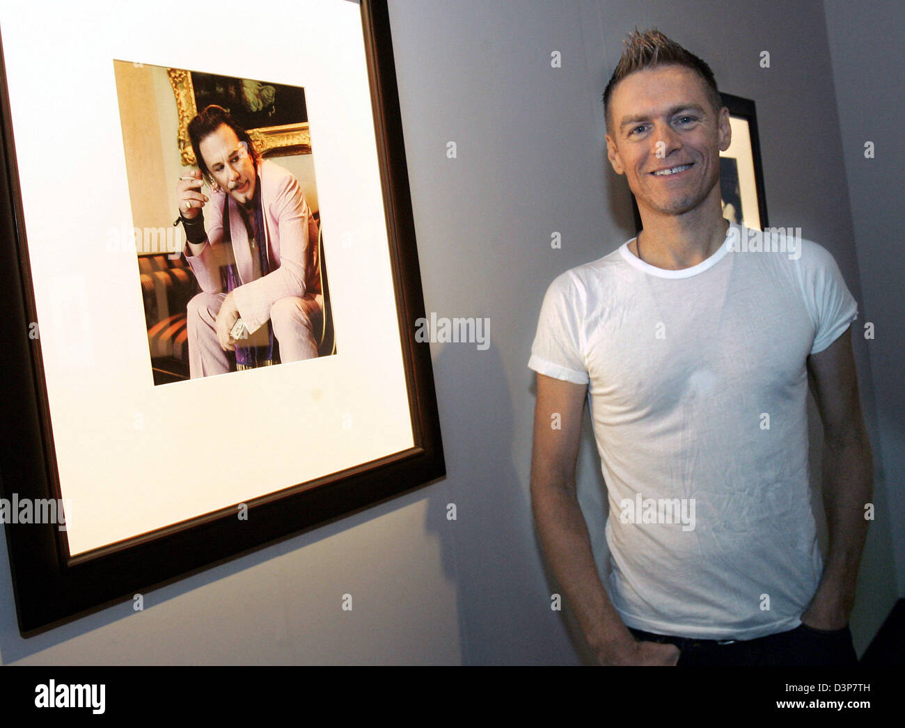 British singer Bryan Adams stands beside one of his photo portraits of ...