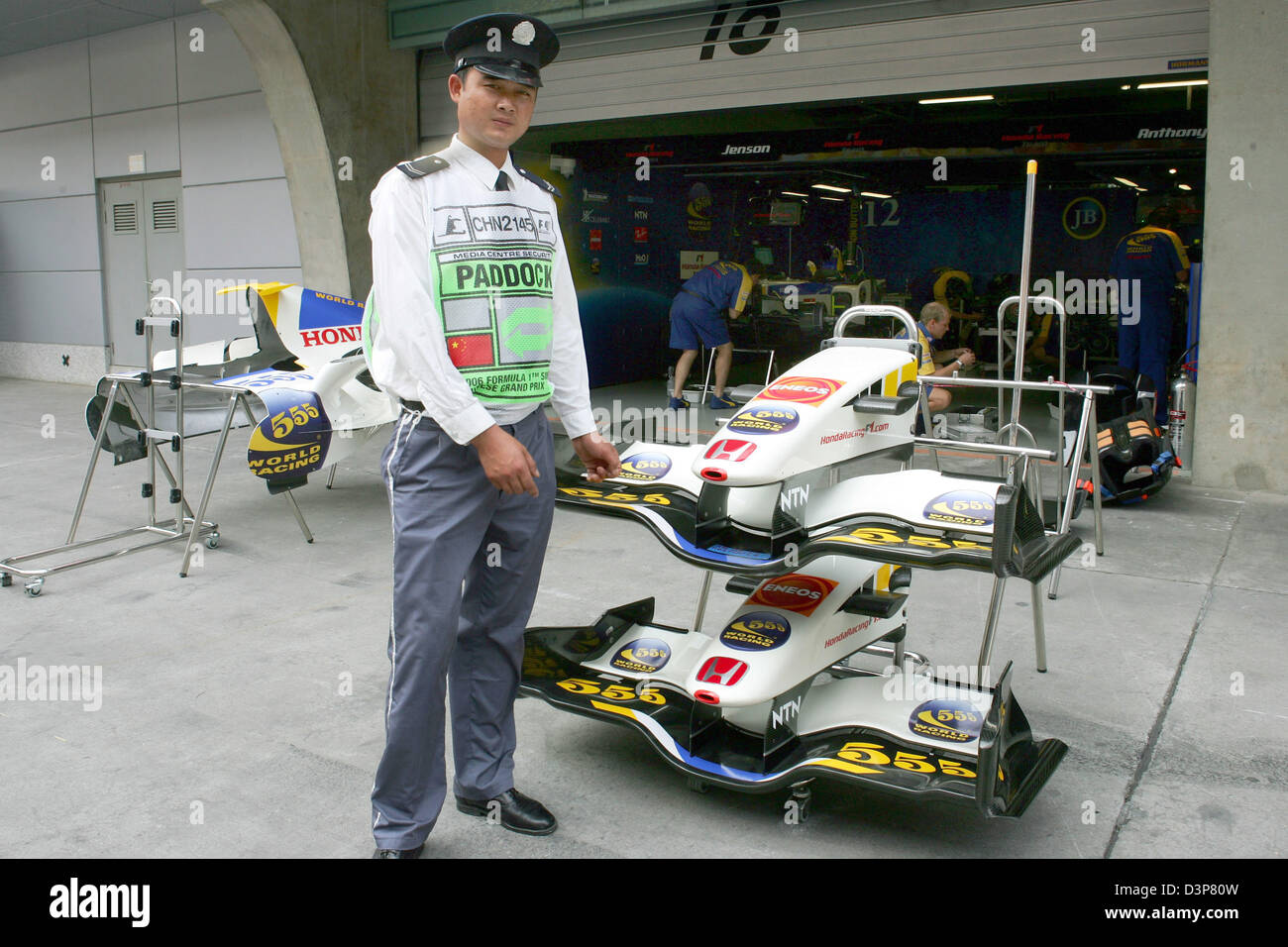 A chinese guard stands in front of the garage of Honda F1 Team at the ...