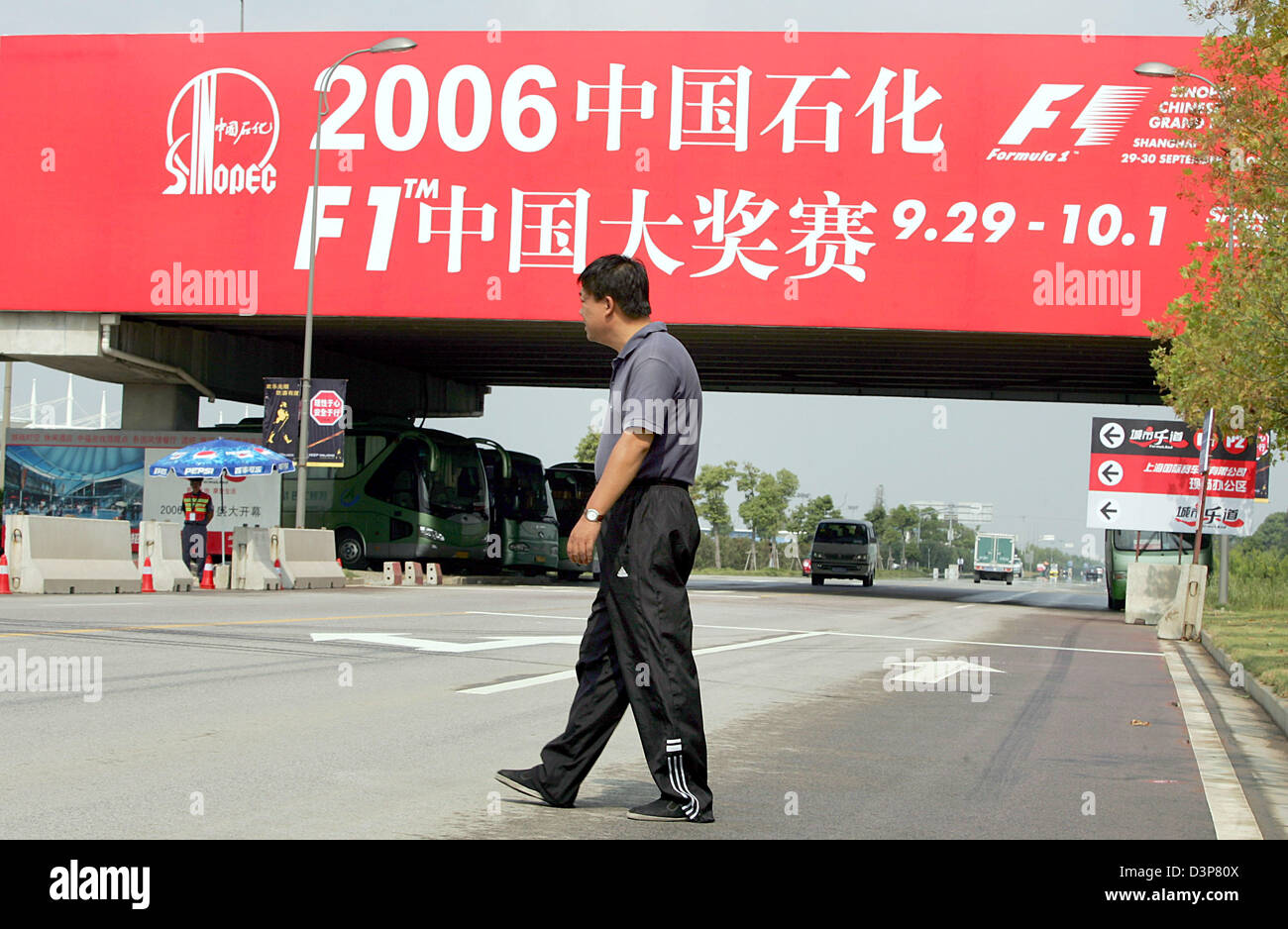A man walks past an advertising board at the F1 racetrack near Shanghai ...