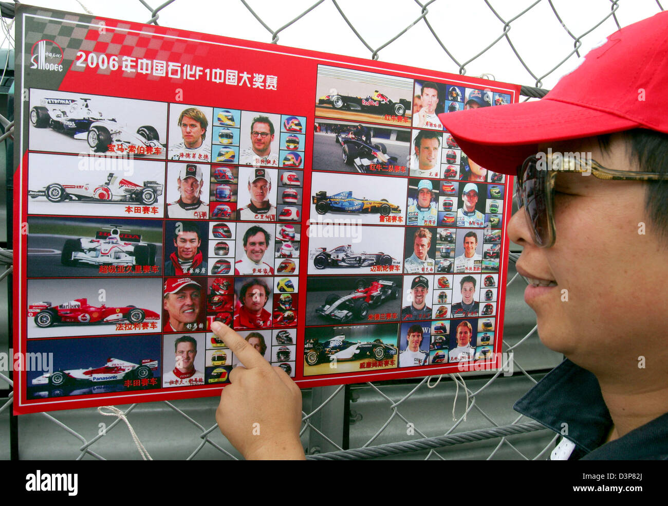 A track marshall points to a picture of Michael Schumacher of Scuderia ...