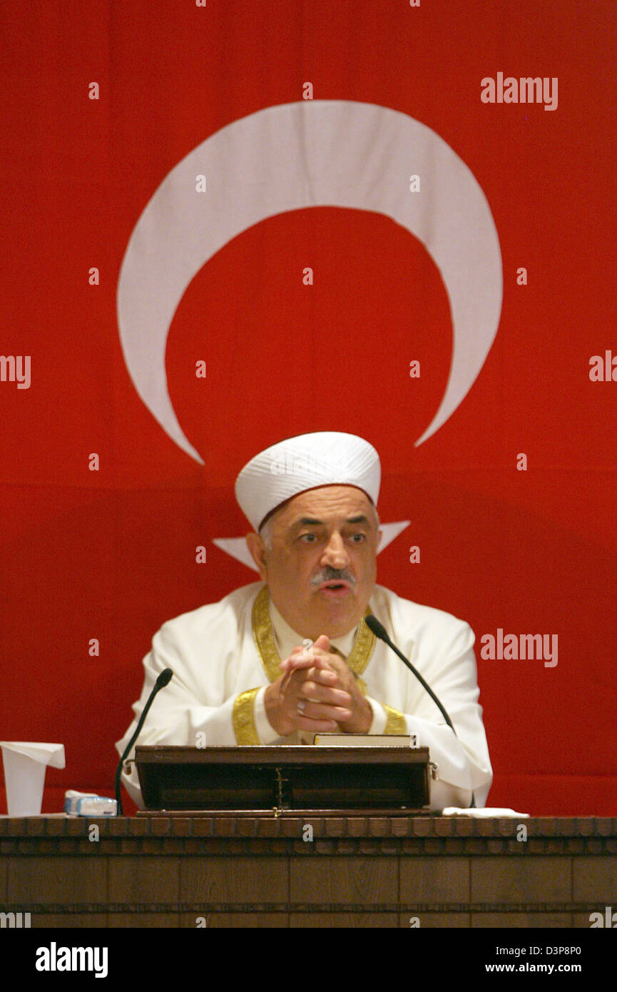 An imam speaks to Turkish muslims prior to the Friday prayer during the ...
