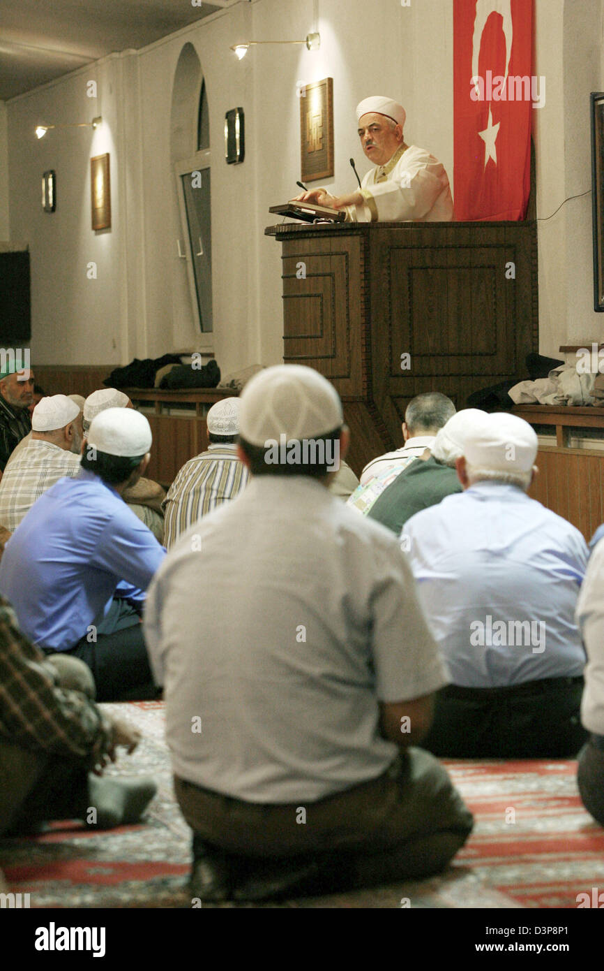 An imam speaks to Turkish muslims prior to the Friday prayer during the ...