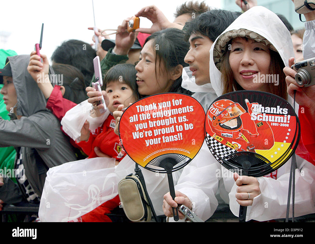 Japanese fans of German Formula One driver Michael Schumacher stand at ...