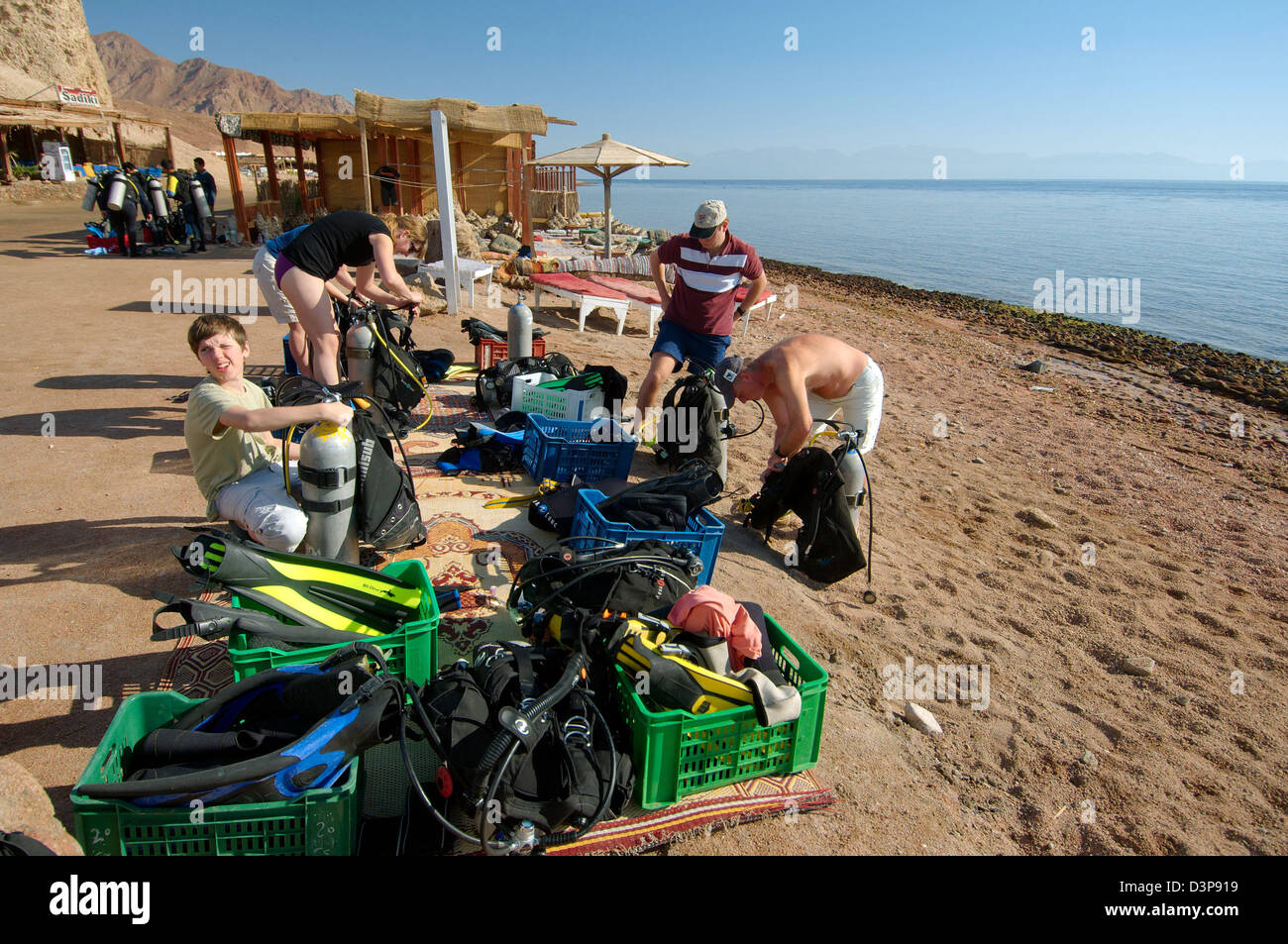 Scuba divers collect equipment on shore, Dahab, Red Sea, Egypt, Africa ...