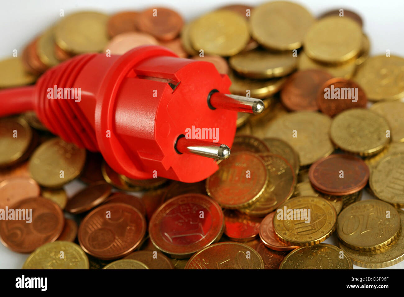 A red plug photographed on top of a pile of coins in Bonn, Germany ...