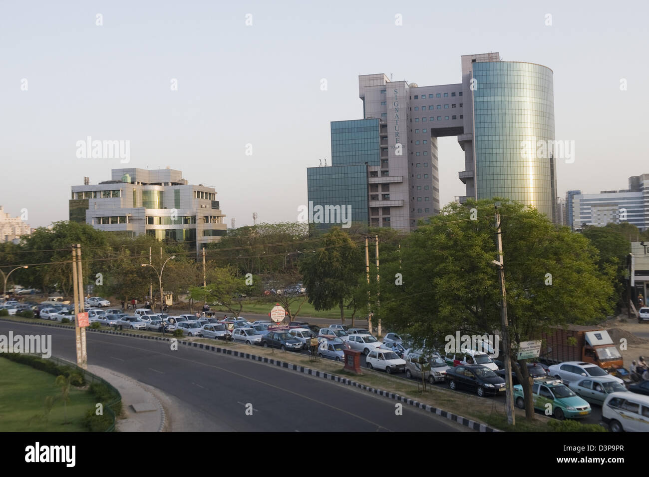Cars waiting at a traffic signal near an office building, Signature ...