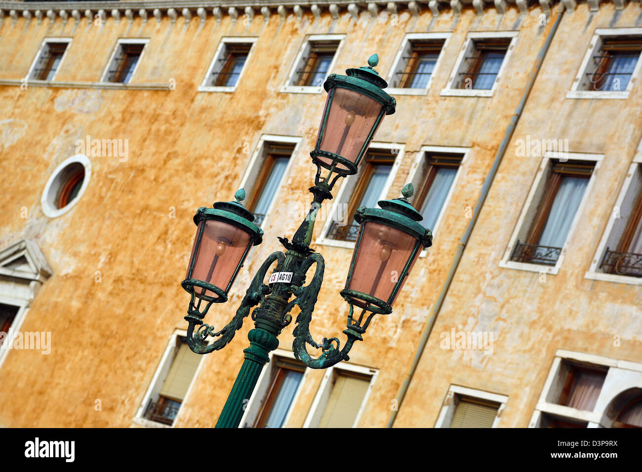 Lamp post and the wall of a building with windows in Venice, Italy ...