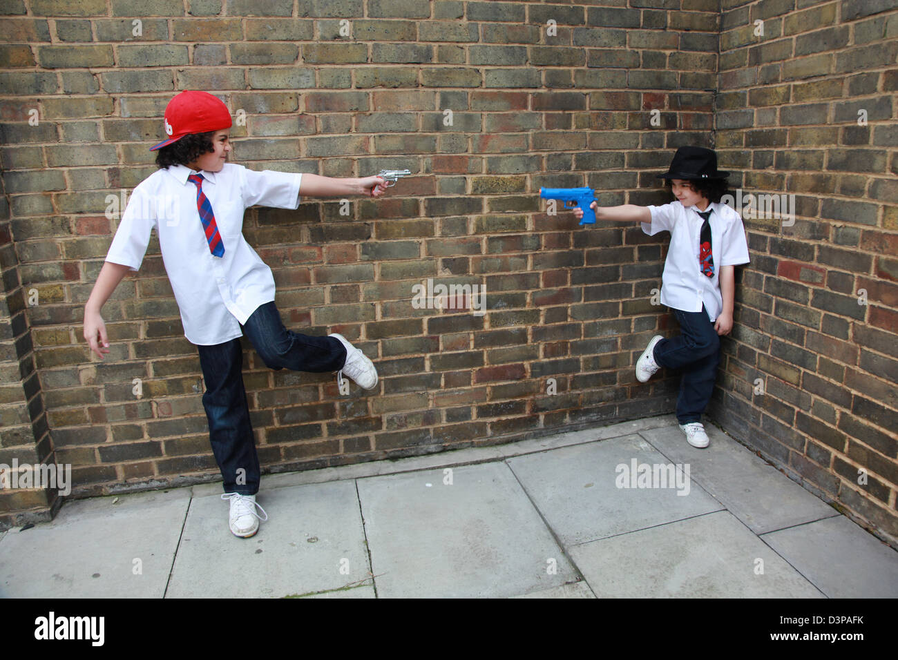 Boys play fighting with toy guns Stock Photo - Alamy