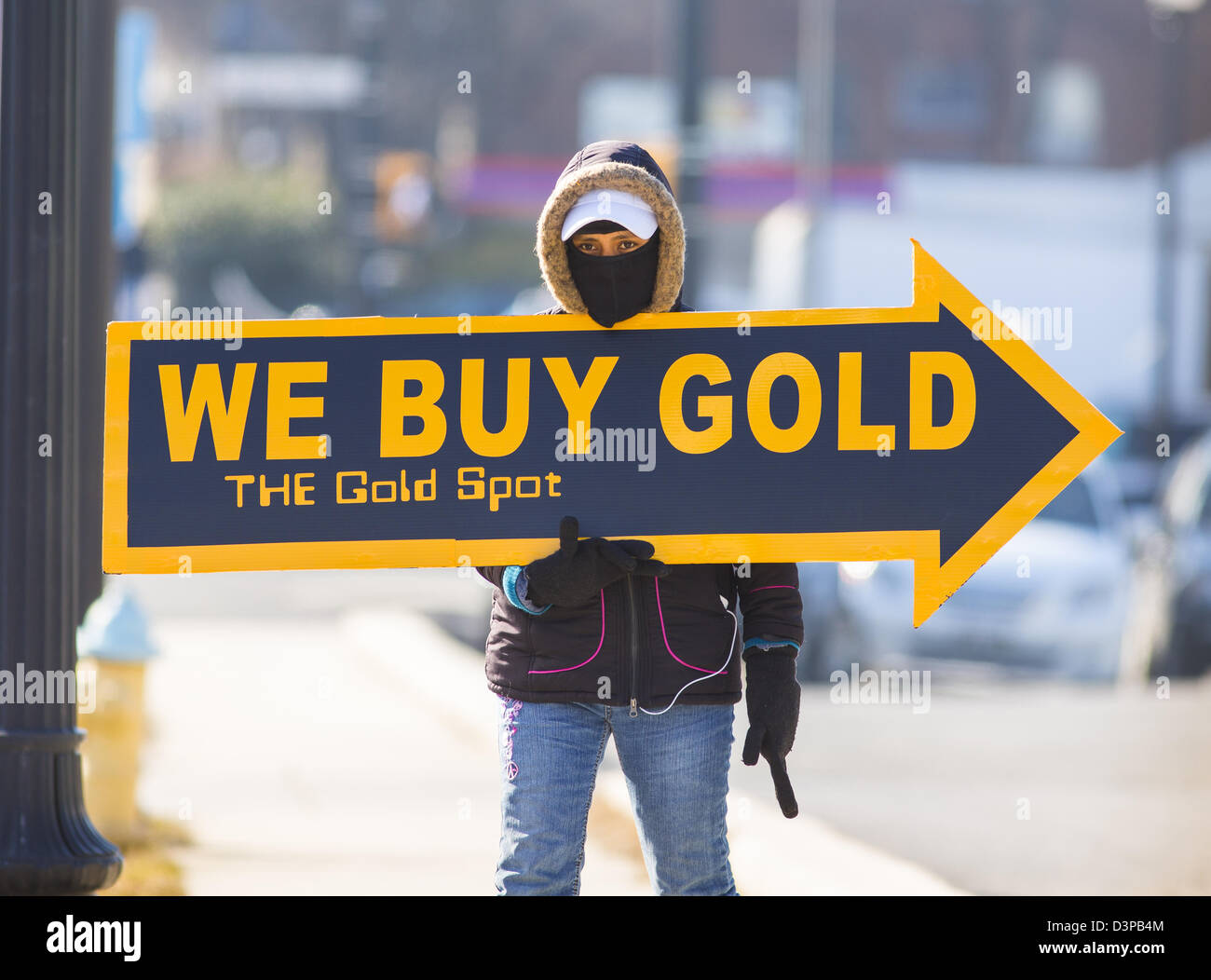 ARLINGTON, VIRGINIA, USA - Woman holds We Buy Gold sign on sidewalk to ...