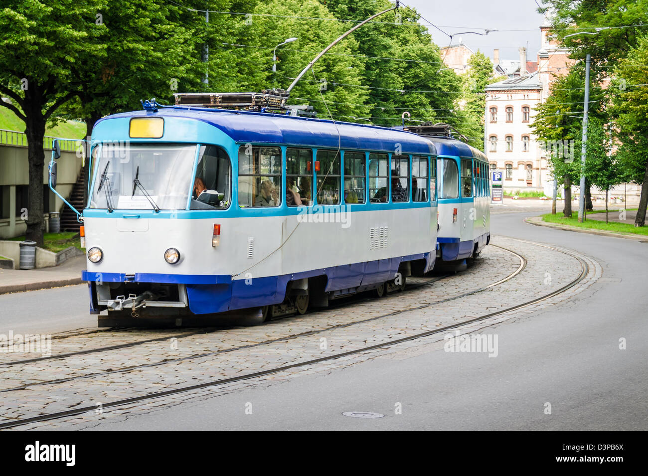 Old European tram moving on the street with passengers on board Stock ...