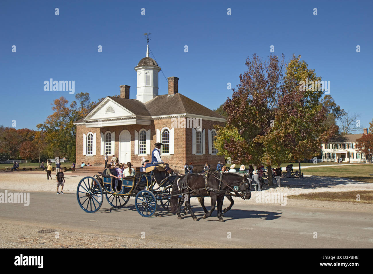 A horse-drawn carriage rides in front of the courthouse building in ...
