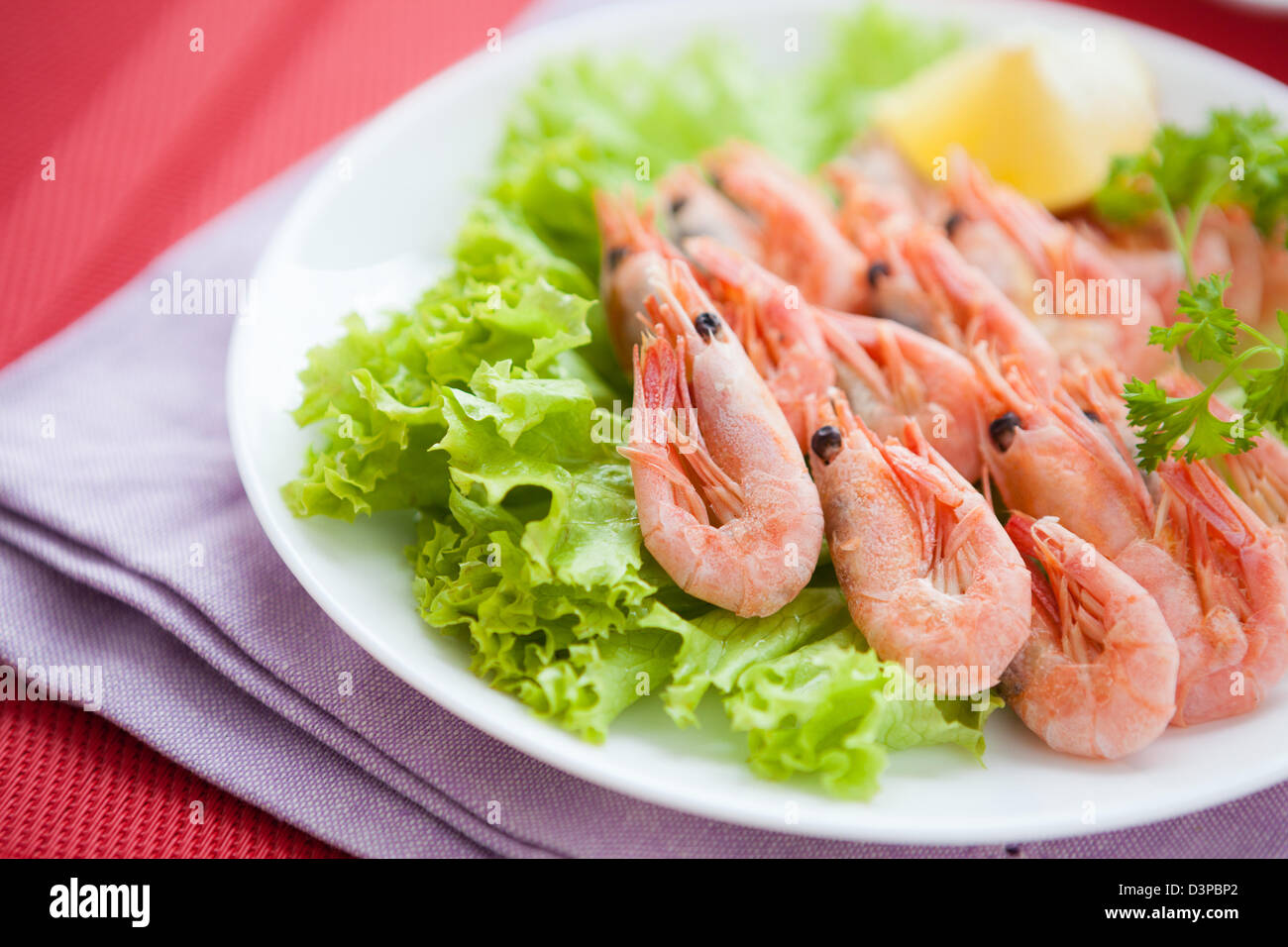 prawns on lettuce leaf on a white plate, seafood closeup Stock Photo ...