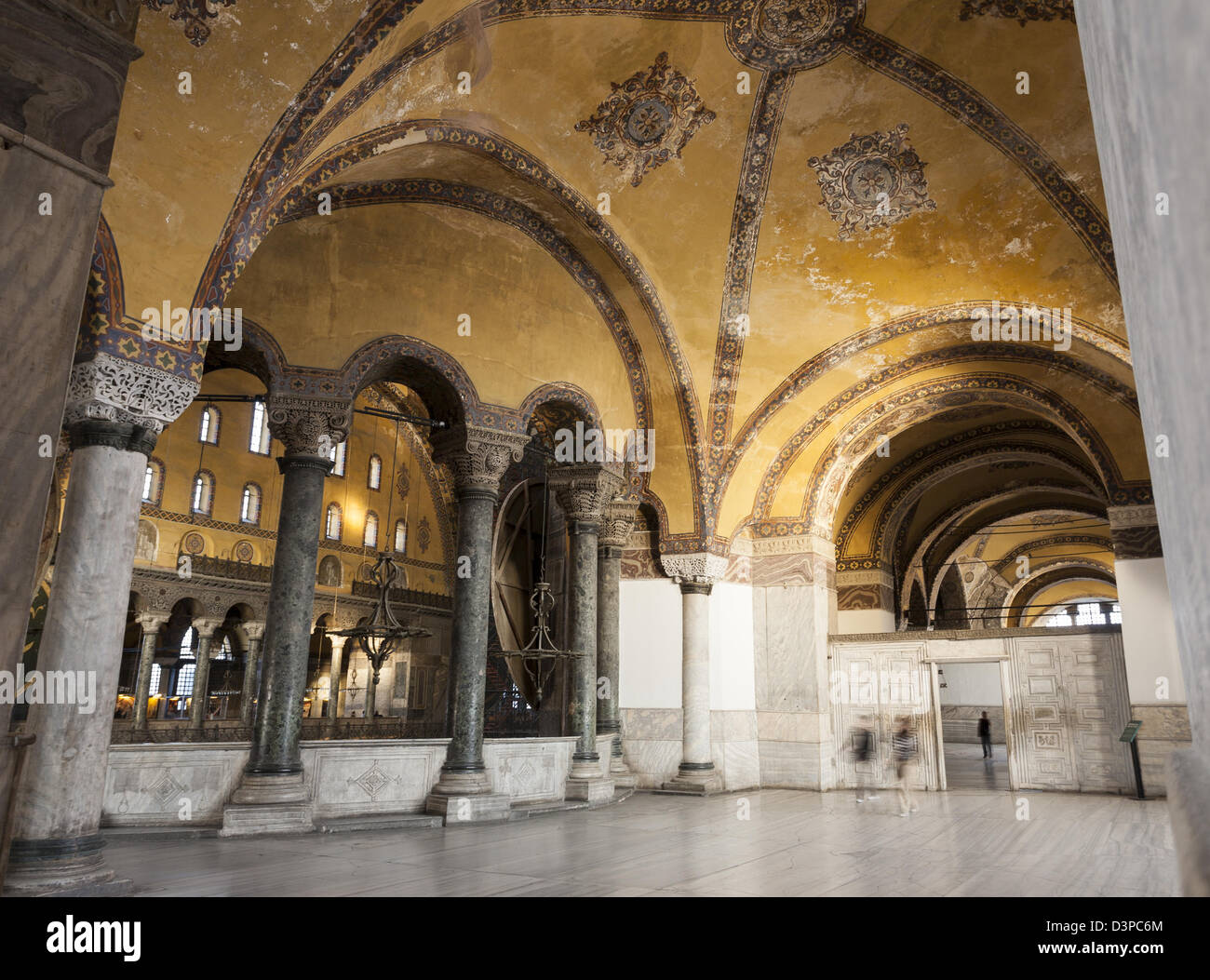 Side Aisle at Hagia Sophia. Blurred tourists walk through a side ...