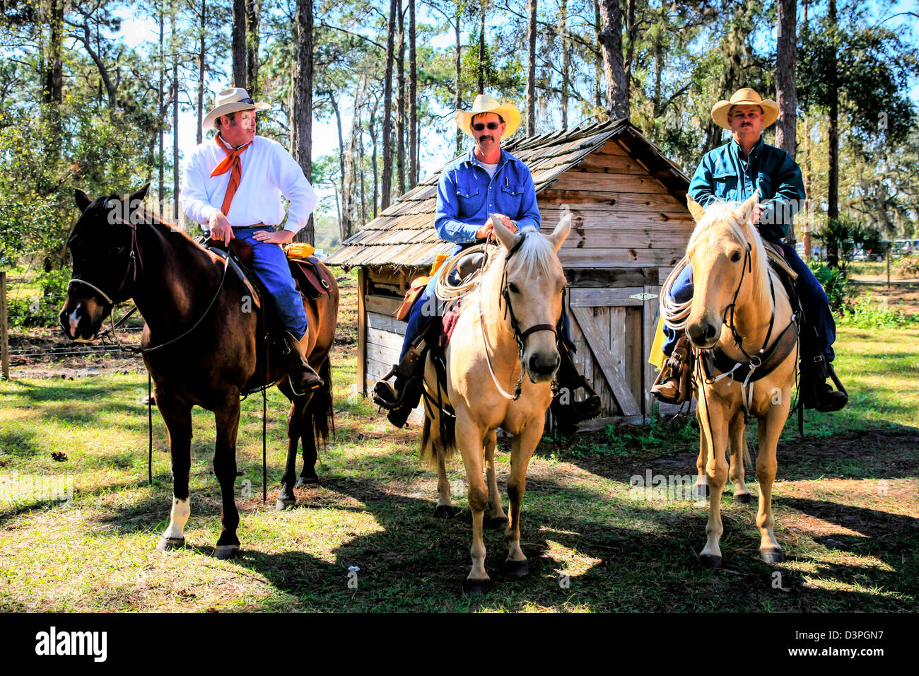 Three cowboys on horseback hi-res stock photography and images - Alamy