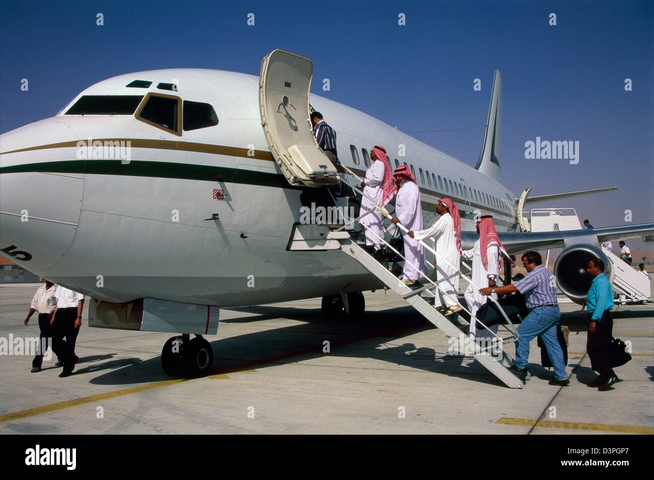 Saudi Aramco employees board the Saudi Aramco 737 company plane at ...