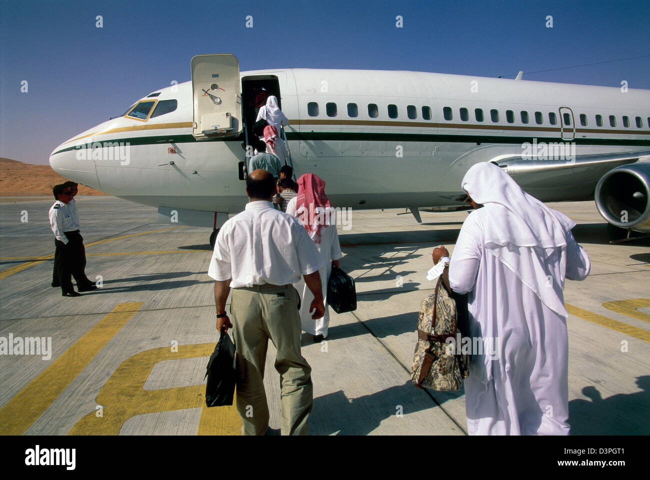 Saudi Aramco employees board the Saudi Aramco 737 company plane at ...