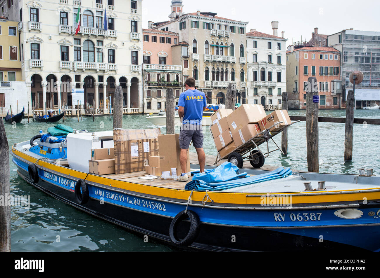 Delivery Barge and Man on the Grand Canal in Venice Stock Photo - Alamy