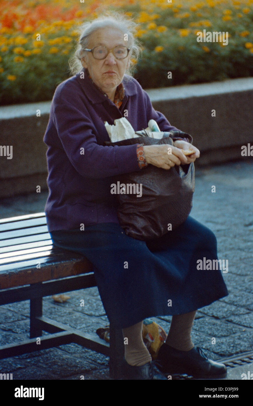 Berlin, GDR, senior citizen sitting on a park bench, lost in thought ...