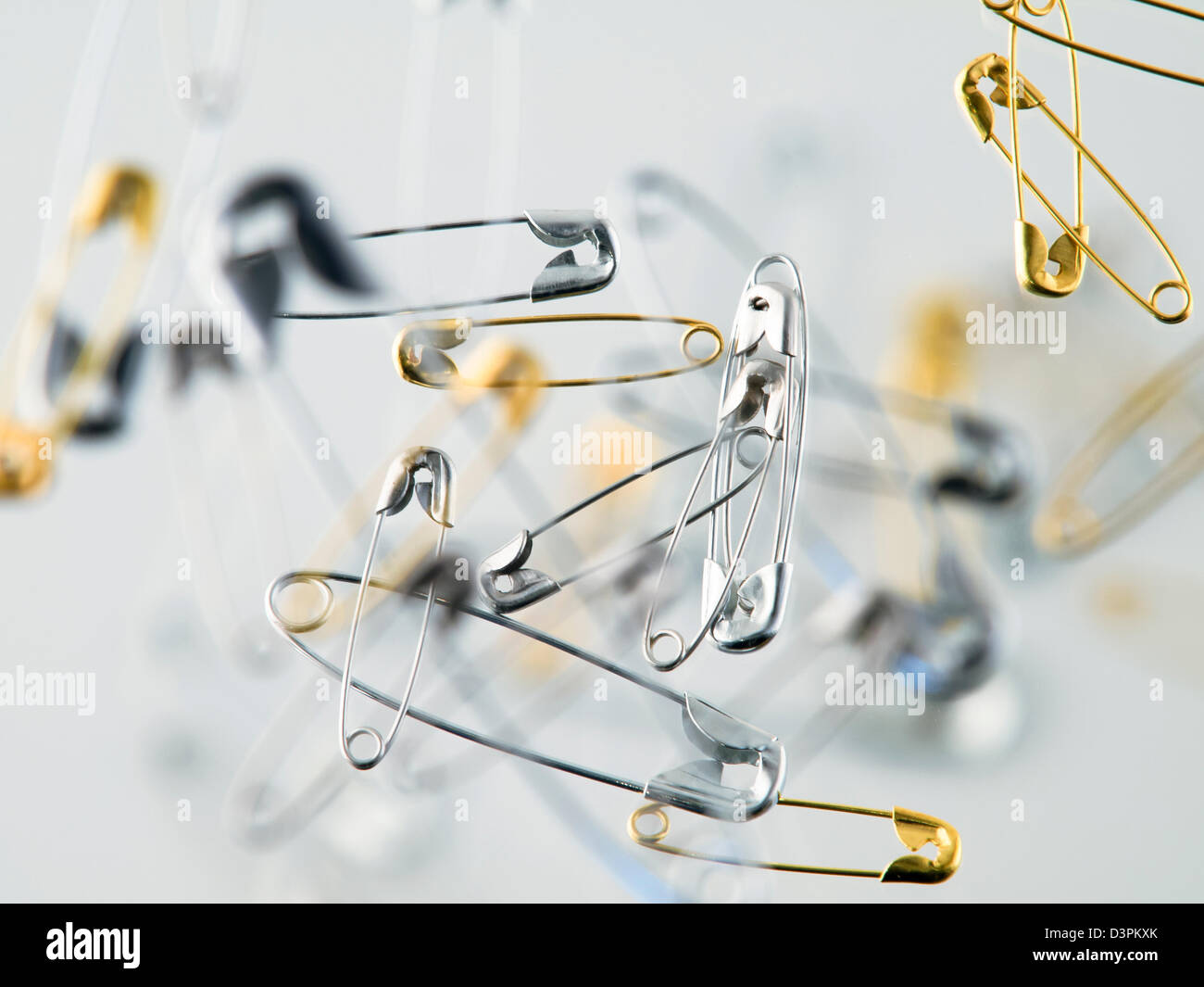 floating safety pin on a white background Stock Photo - Alamy