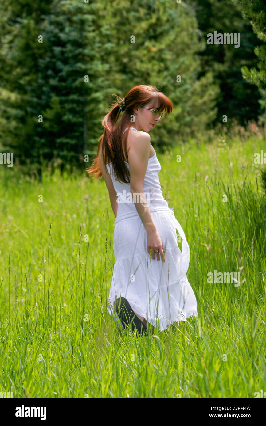 Young woman up in the Colorado mountains on a beautiful summer day ...