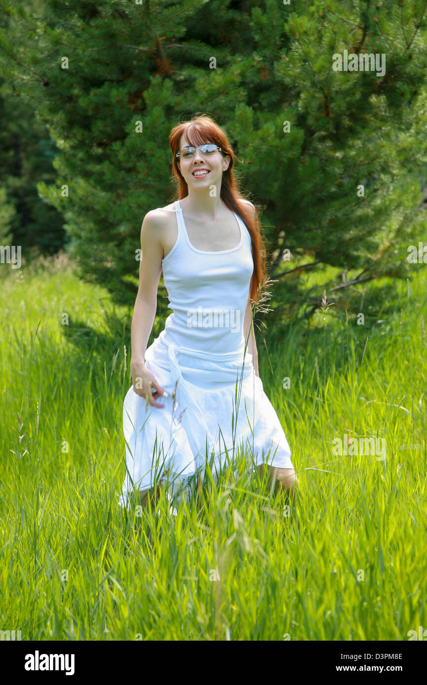 Young woman up in the Colorado mountains on a beautiful summer day ...
