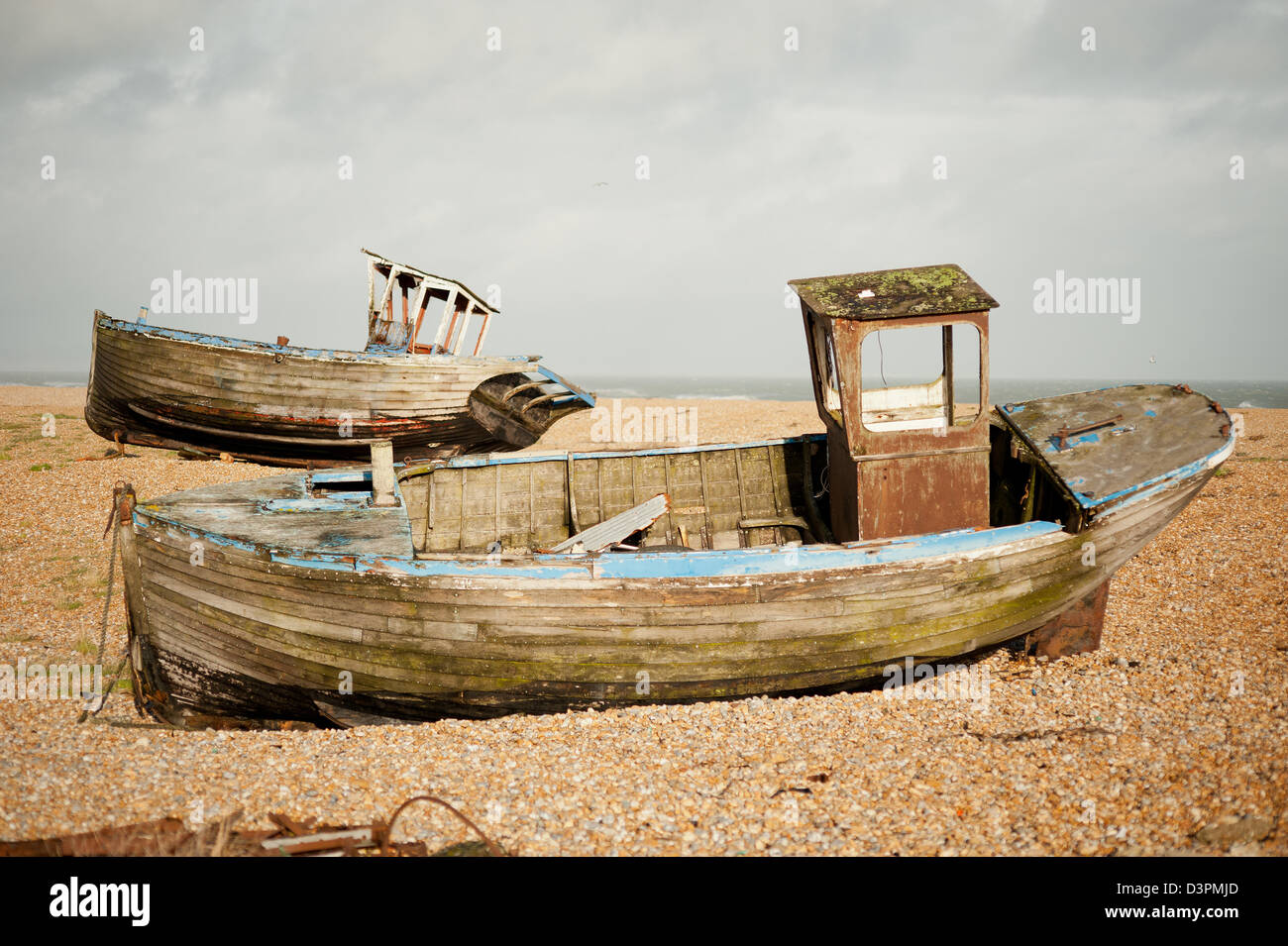 Old abandoned wooden fishing boats on the shingle beach at Dungeness in ...