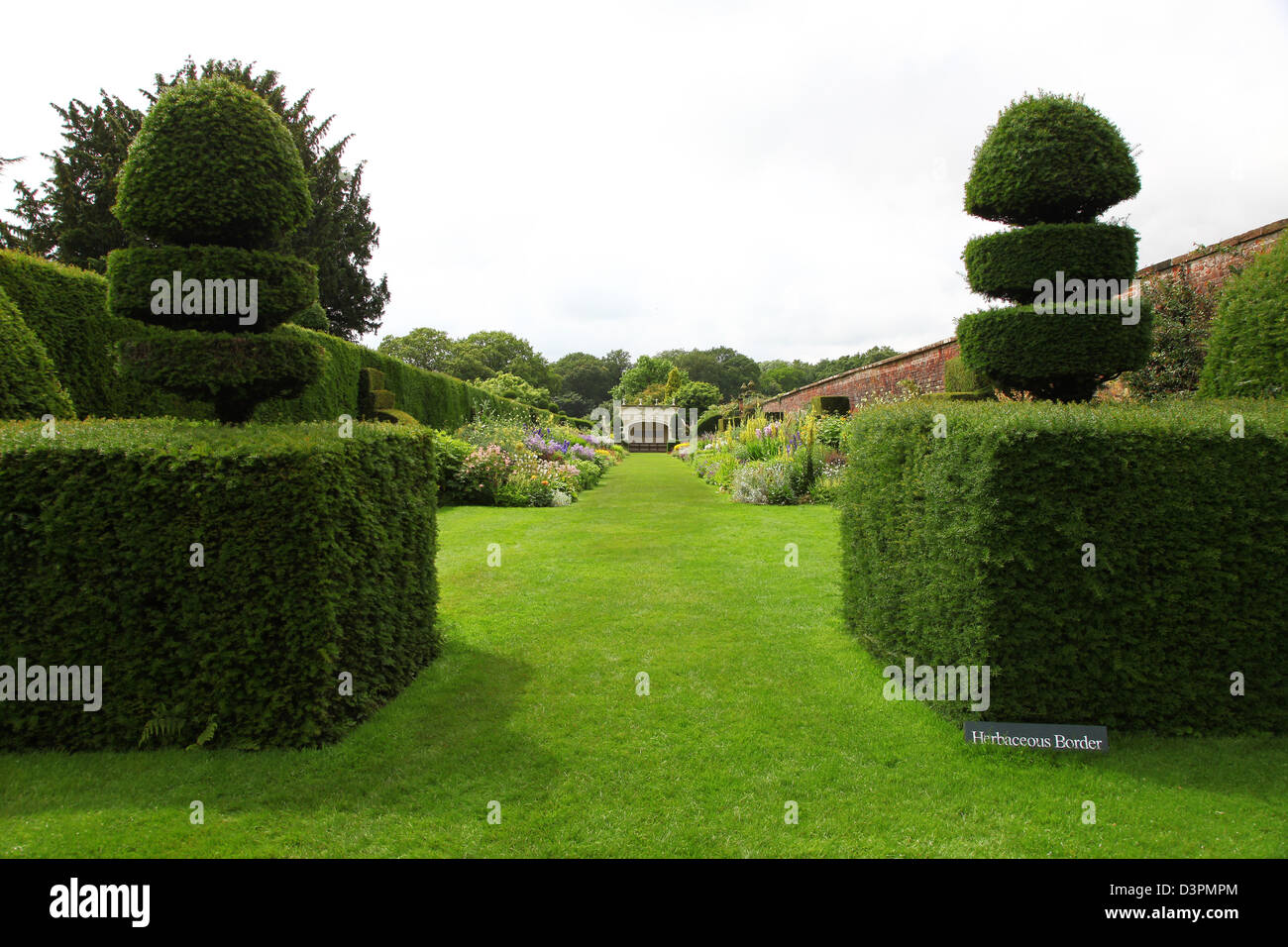 The formal planting and topiary in the herbaceous border looking toward ...