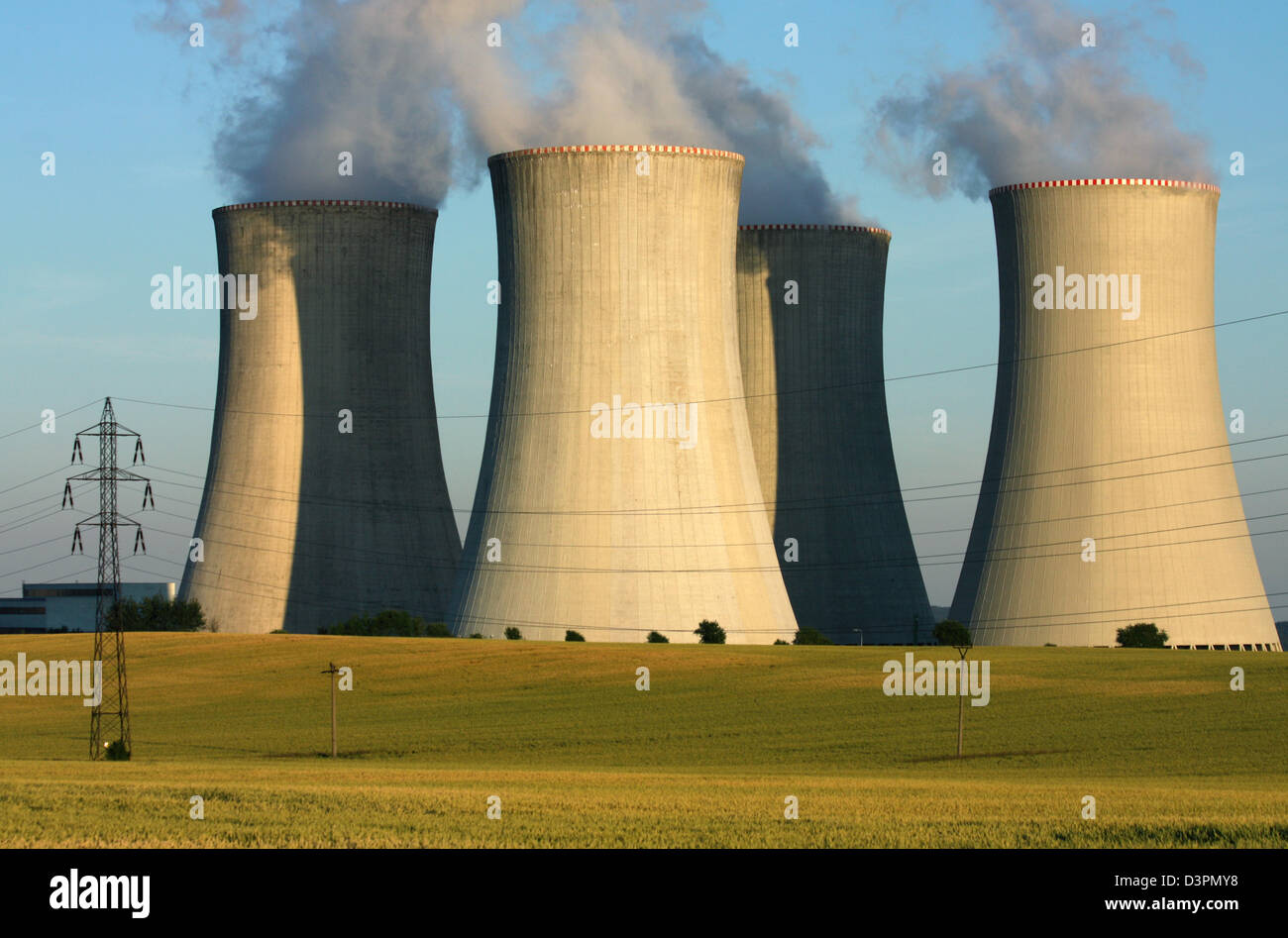 power plant four cooling towers in agriculture field Stock Photo - Alamy