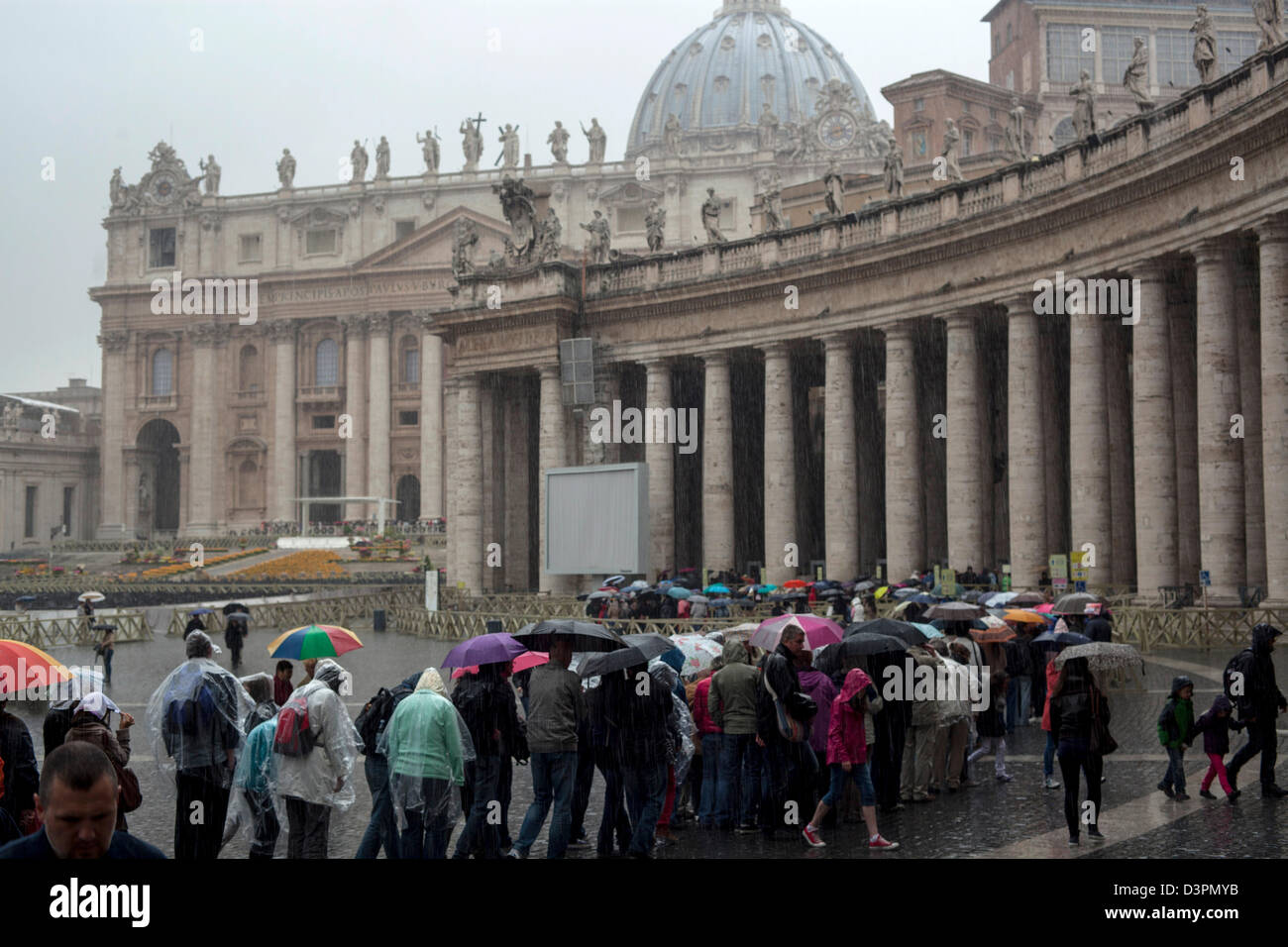 Tourists queue in heavy rain to enter St Peter's basilica at the ...