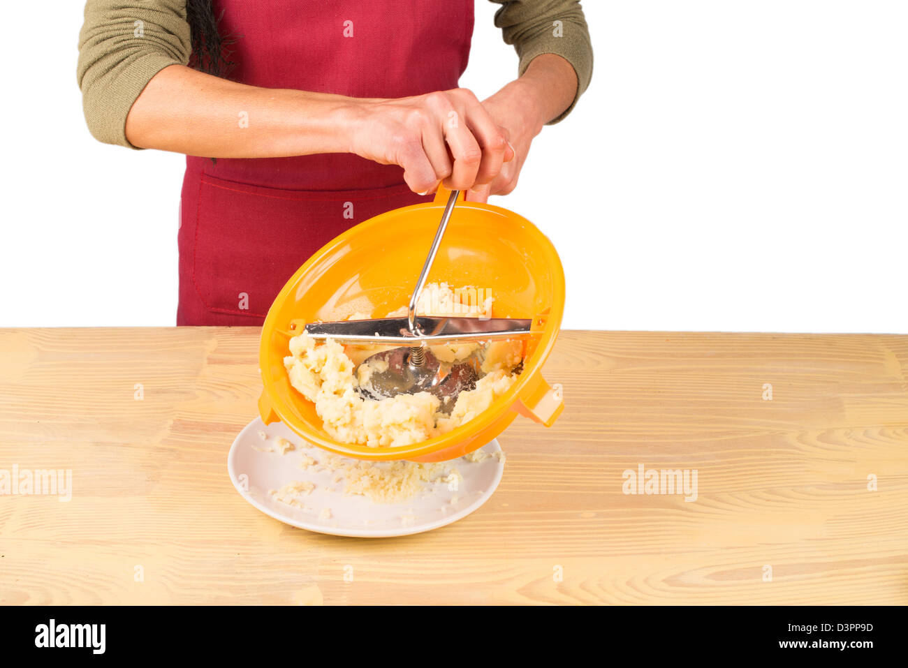 Mashing potatoes using a food mill Stock Photo - Alamy