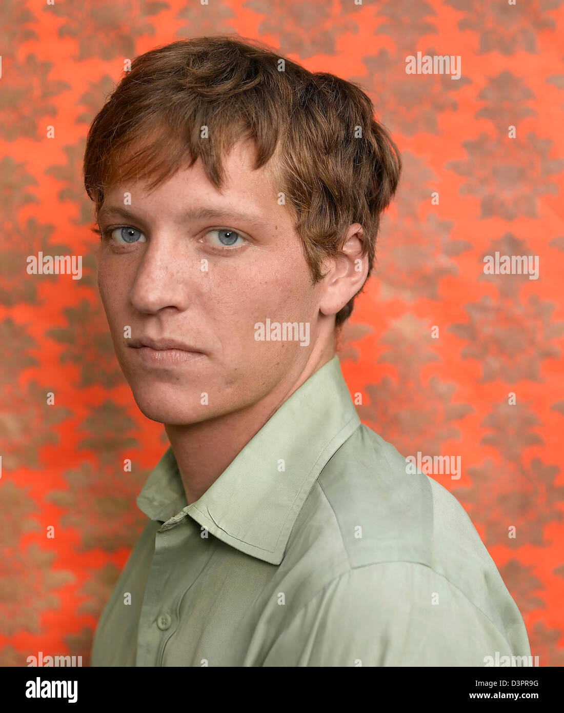 Porraits of people in front of orange wallpaper Stock Photo - Alamy