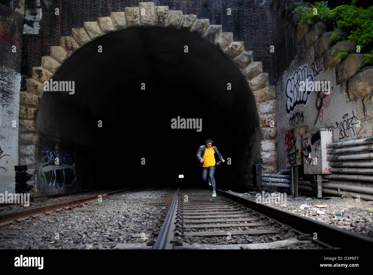 Man running on train tracks Stock Photo - Alamy