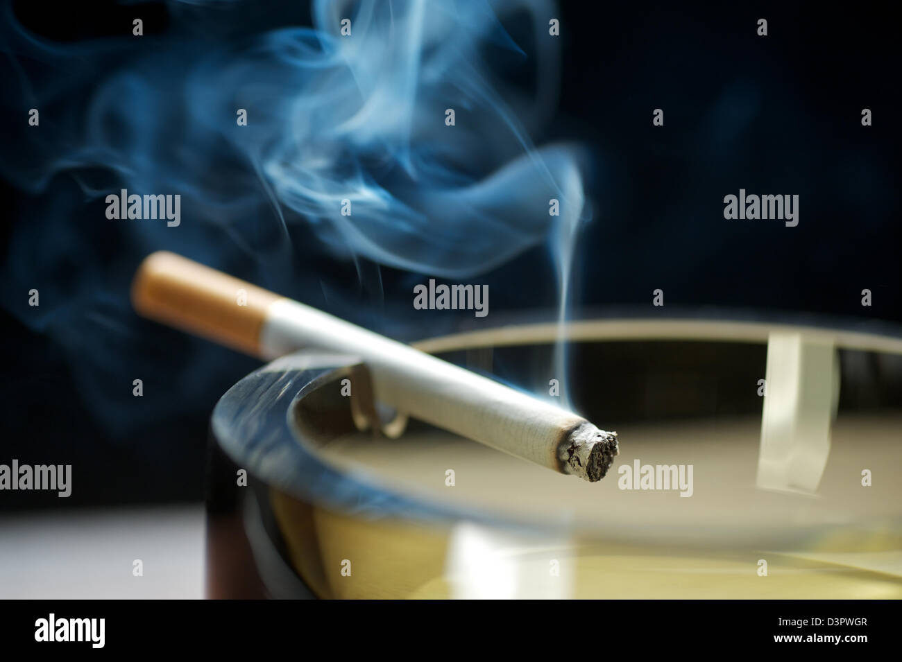 Hamburg, Germany, a smoking cigarette in an ashtray Stock Photo - Alamy