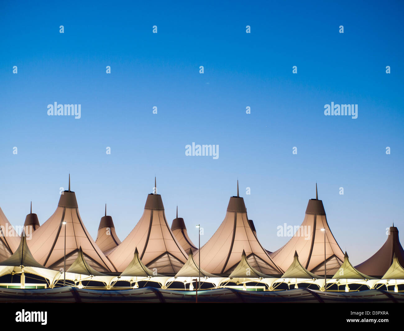Glowing tents of DIA at sunrise. Denver International Airport well ...