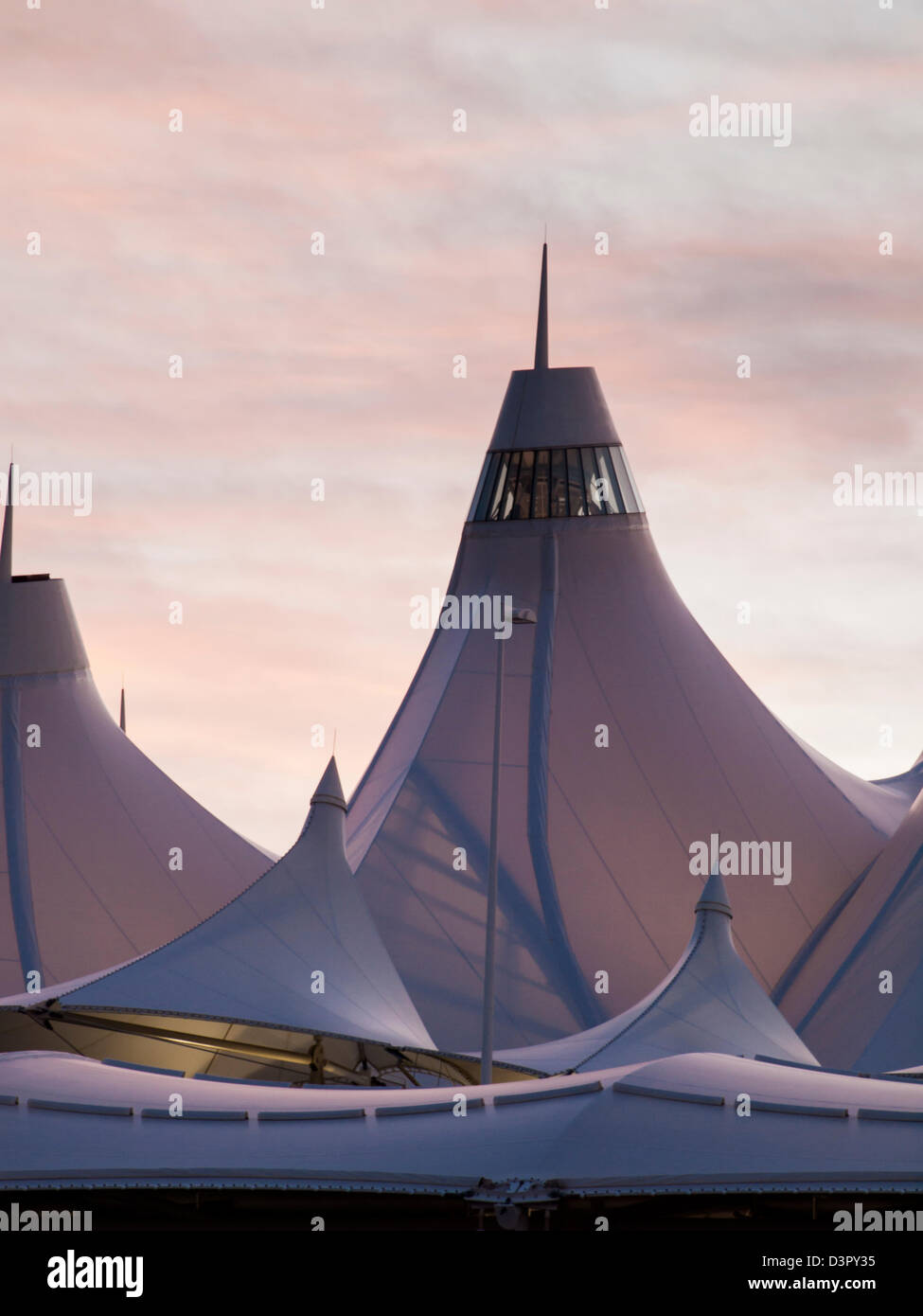Glowing tents of DIA at sunrise. Denver International Airport well ...