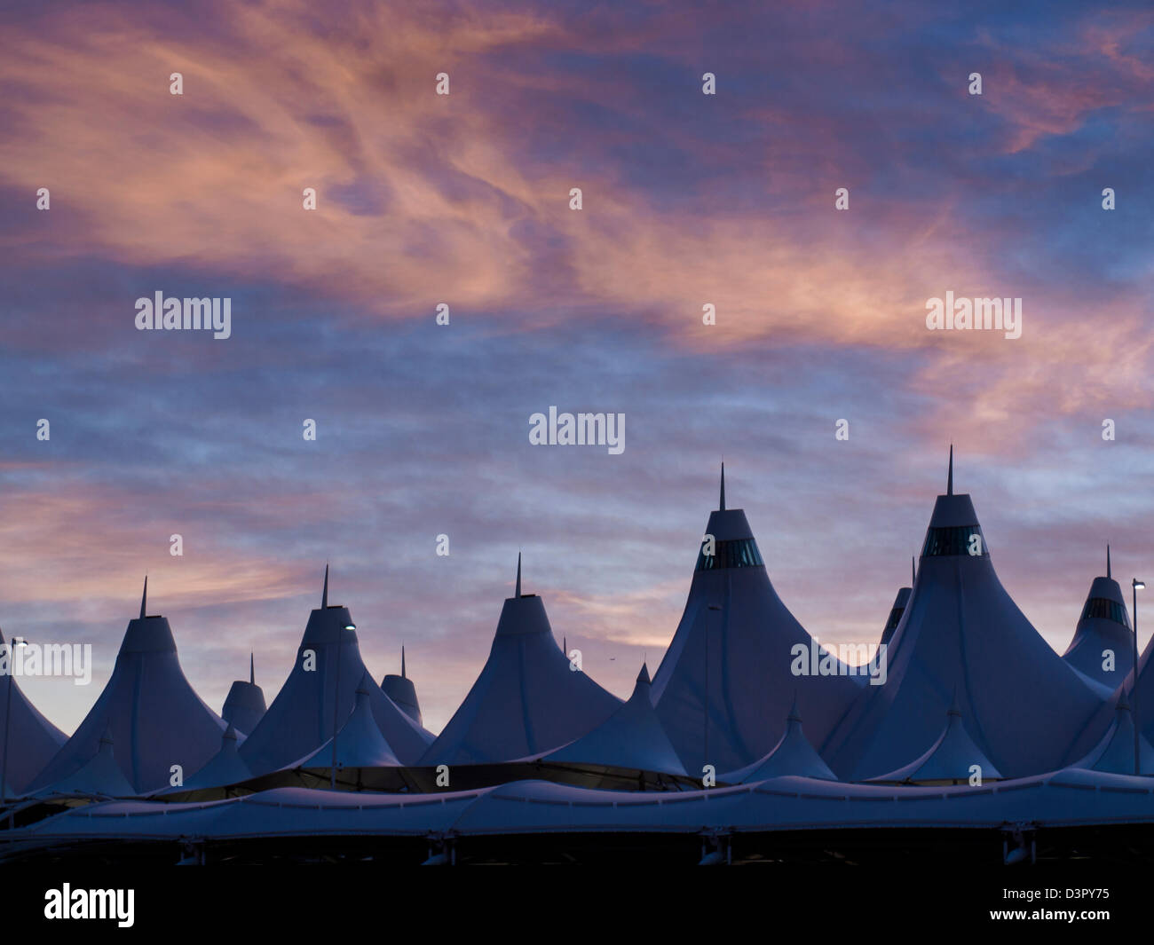 Glowing tents of DIA at sunrise. Denver International Airport well ...