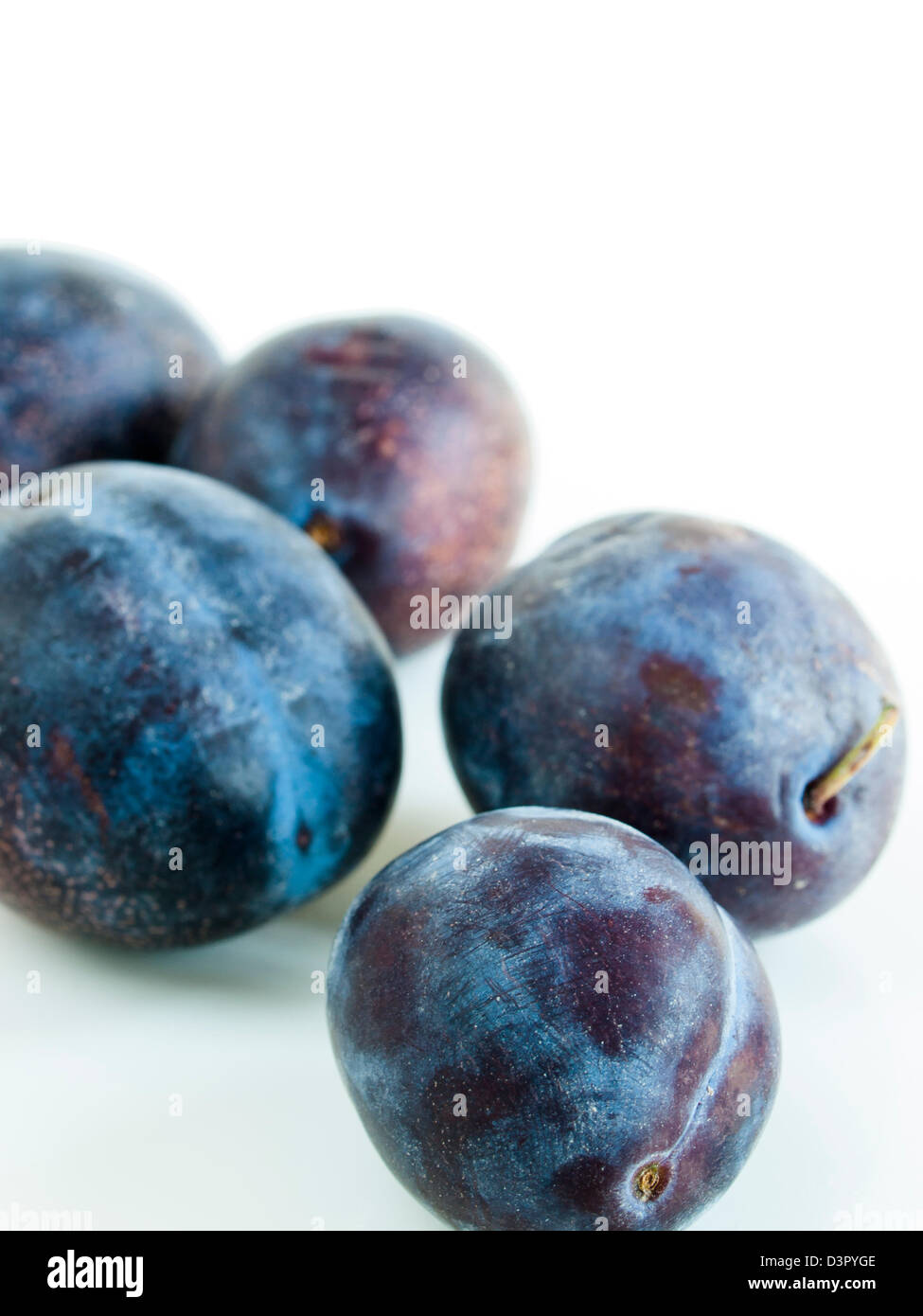 Fresh plums on white background Stock Photo - Alamy