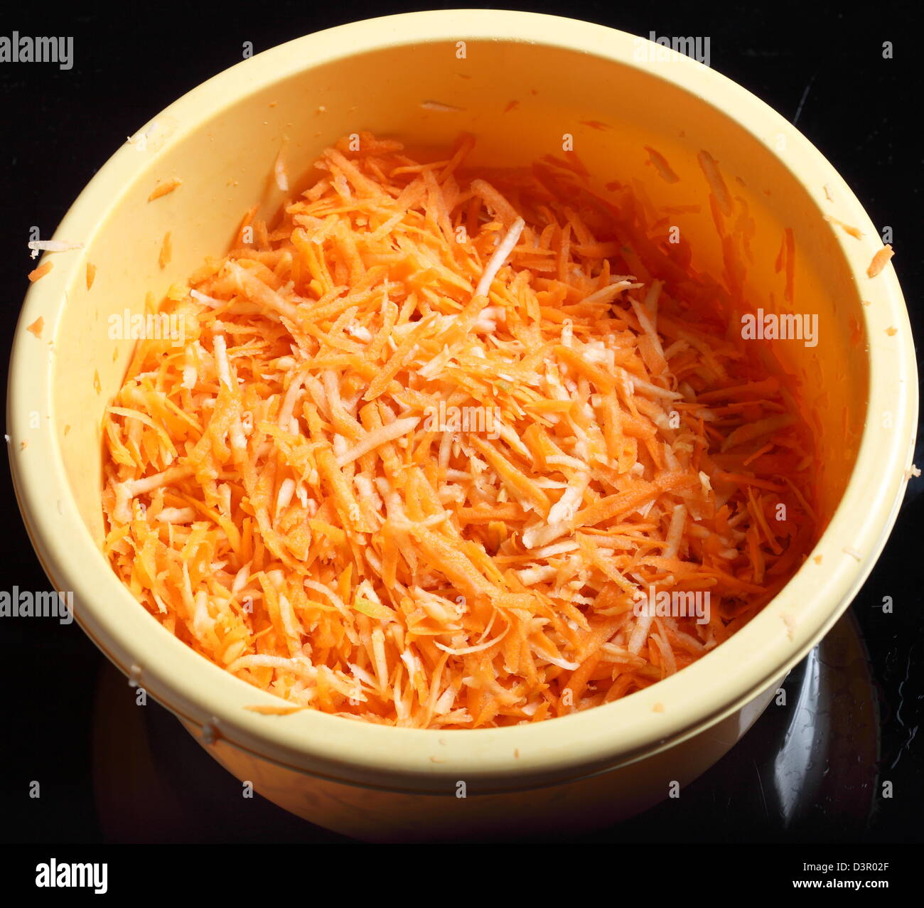 grated carrots in a bowl vegetables salad black background Stock Photo ...